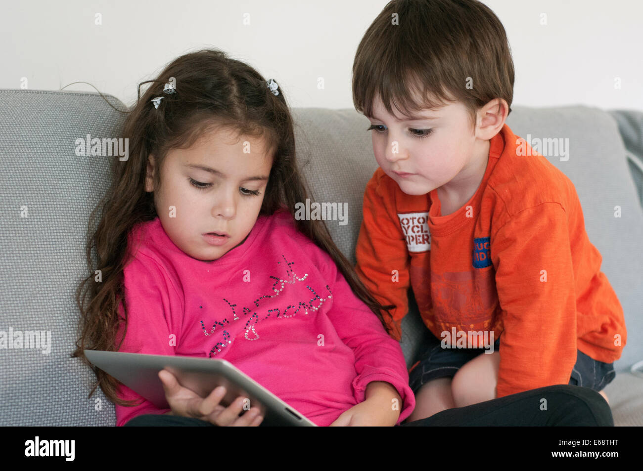 Children playing tablet home hi-res stock photography and images - Alamy
