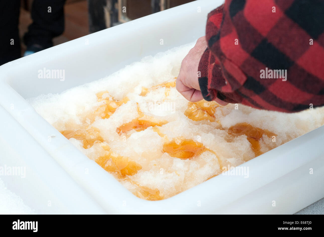 Maple syrup taffies on snow at traditional sugar shack Eastern ...