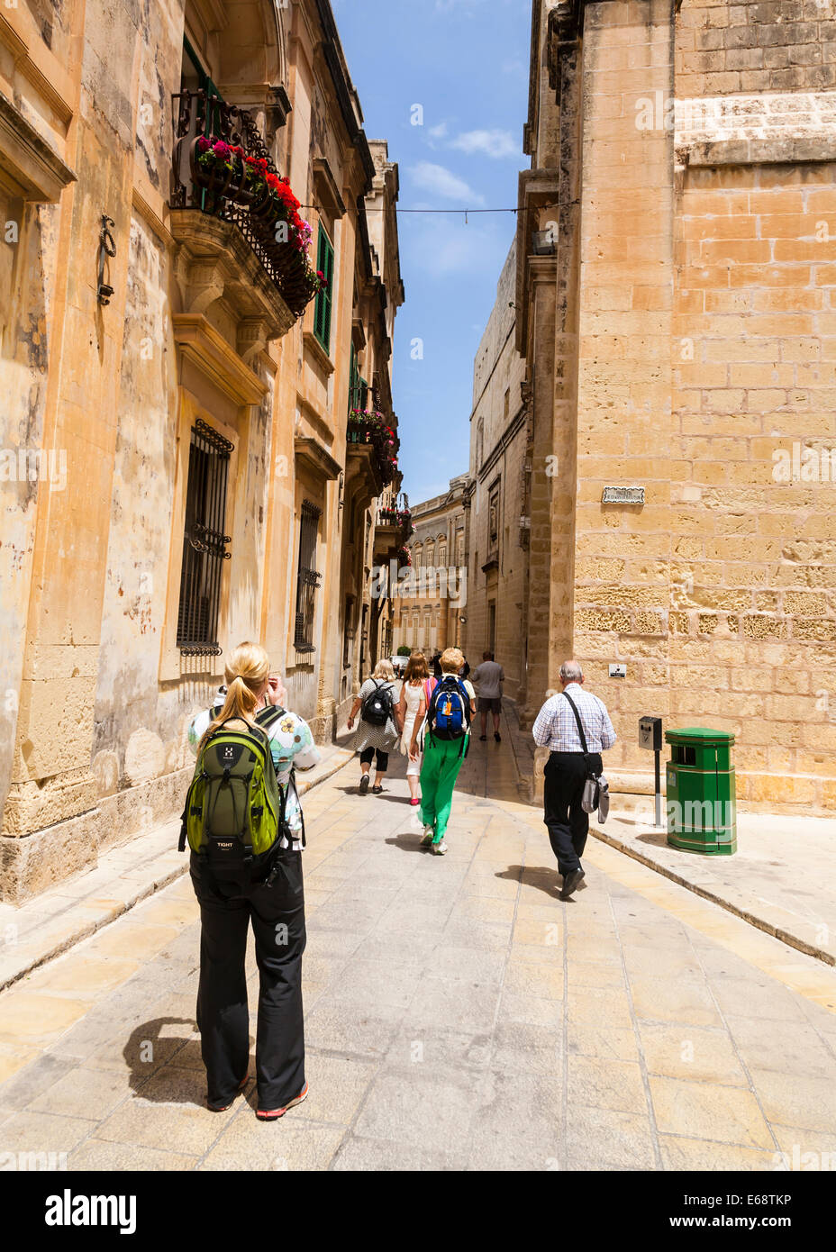 A group of tourists heading down one of Mdina's narrow streets, Malta ...