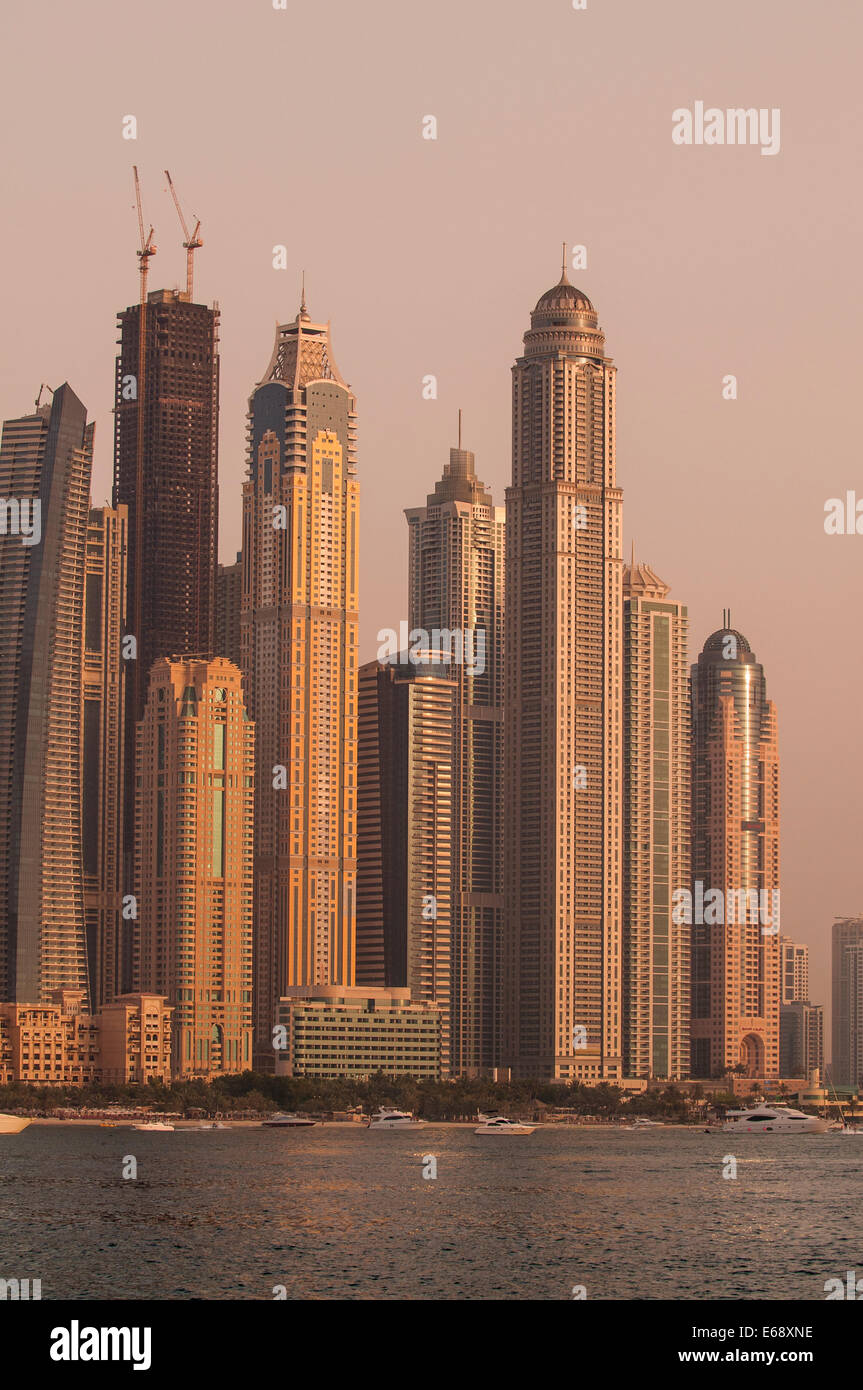 A sunset skyline cityscape of buildings towers around the Dubai Marina ...