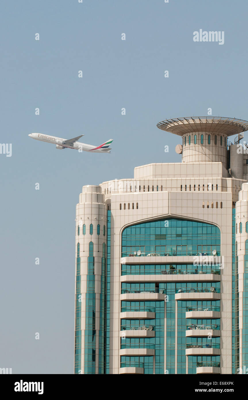 Jet airliner plane airplane over office building in the Dubai Creek, Al ...