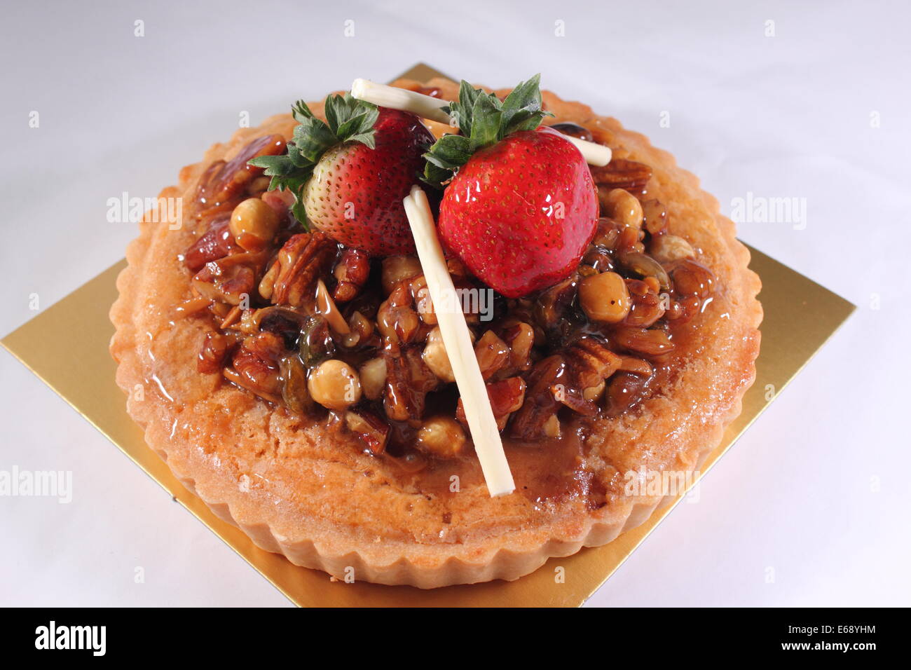 A Mixed nuts pie decorated with strawberry Stock Photo - Alamy