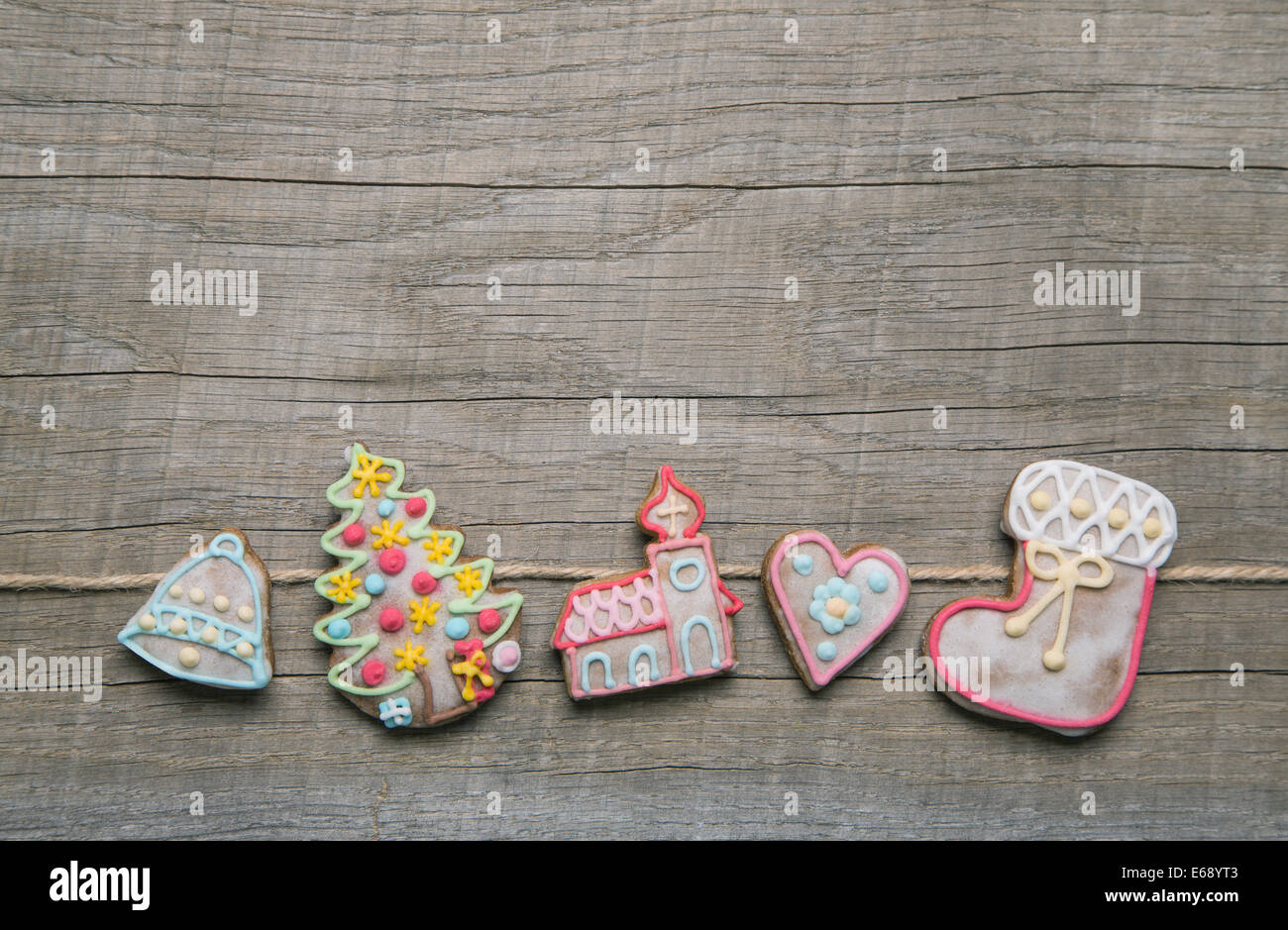 Icing gingerbread in pastel colors decorated on a wooden background for ...