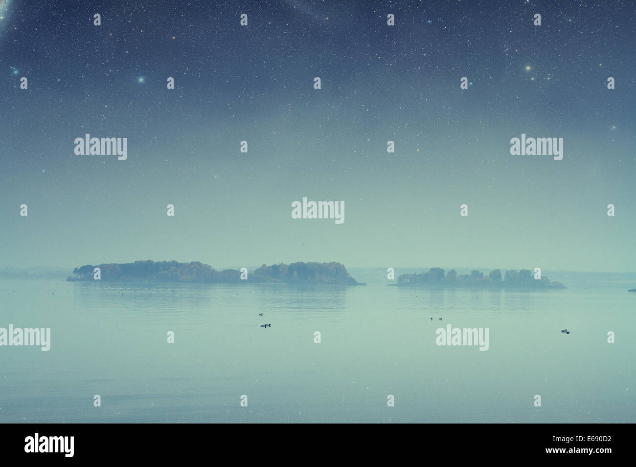 island in the ocean at night. Elements of this image furnished by NASA ...