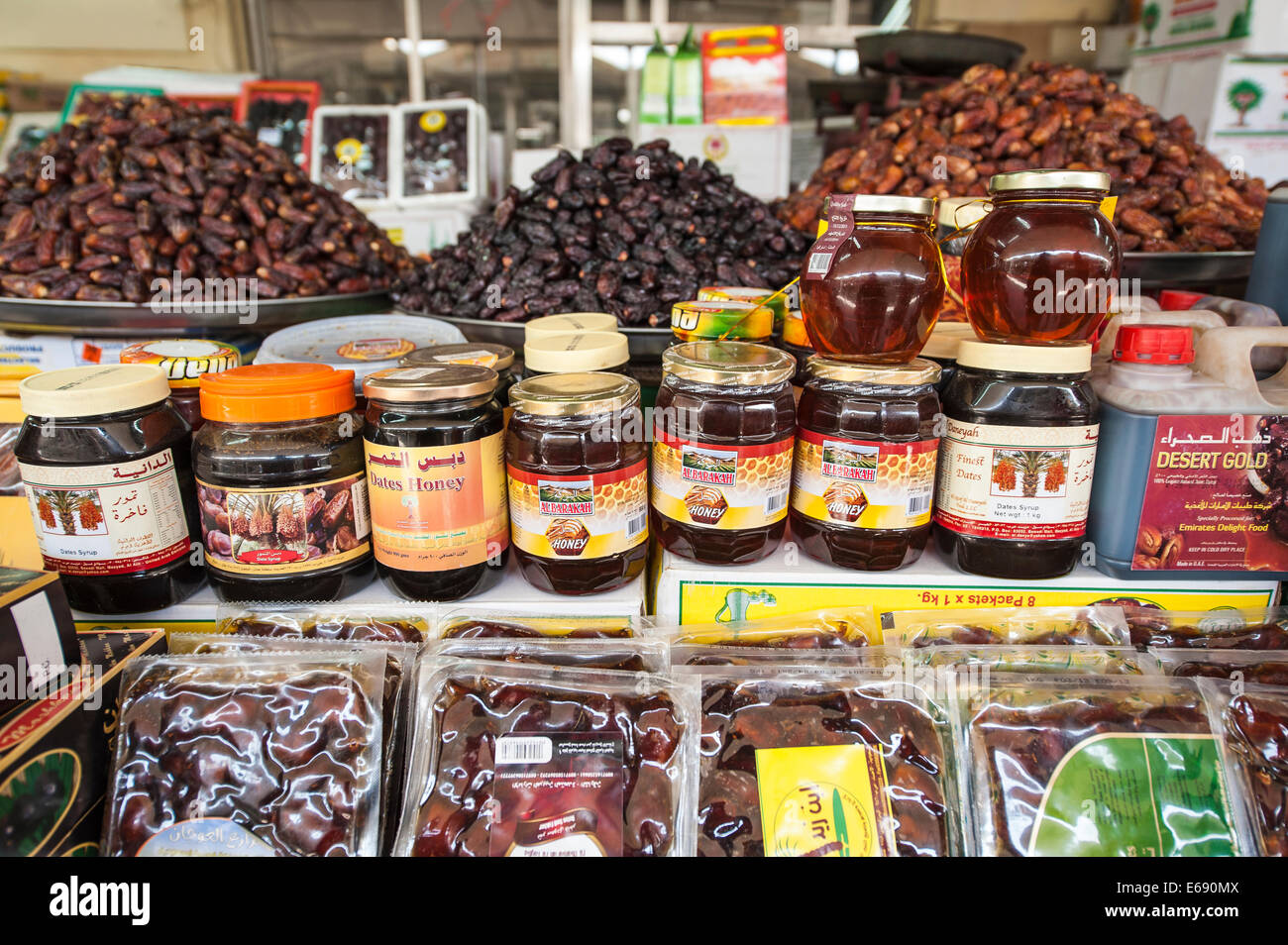 Piles of dates and jars of jam jelly at the Deira produce Souk Market ...