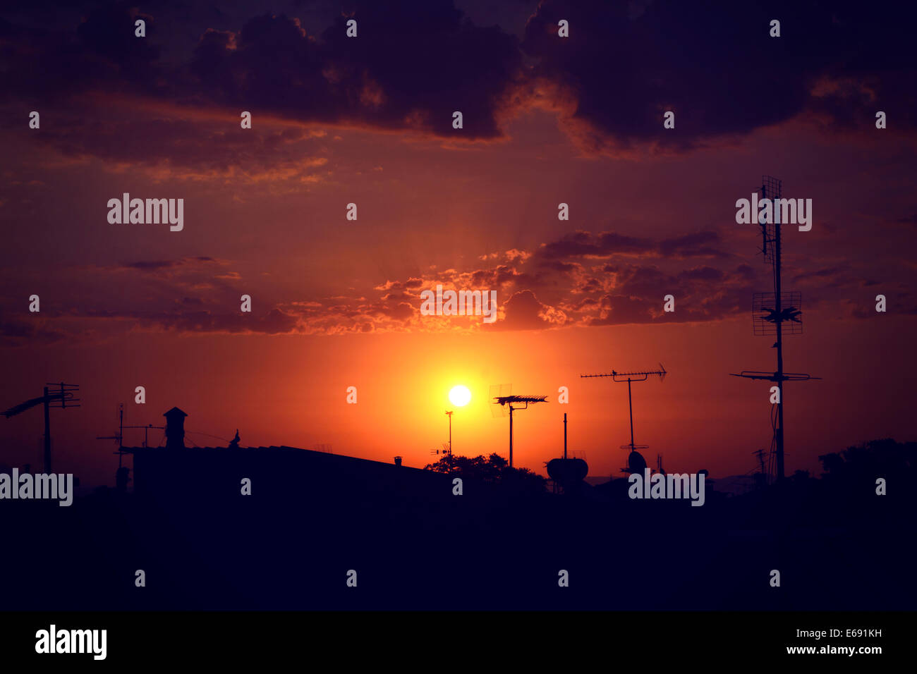 Clouds and dramatic sunset over the roof Stock Photo - Alamy