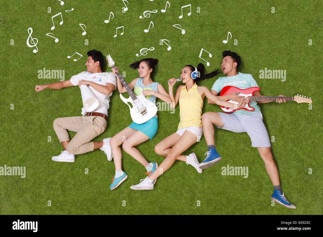 Young people on grass playing musical instruments Stock Photo - Alamy