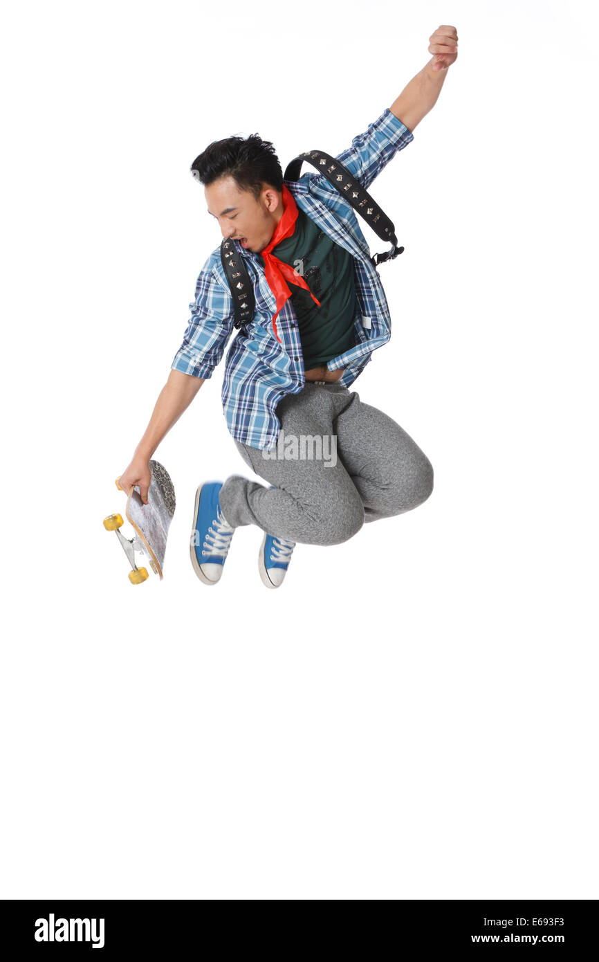 Young man playing skateboard Stock Photo - Alamy
