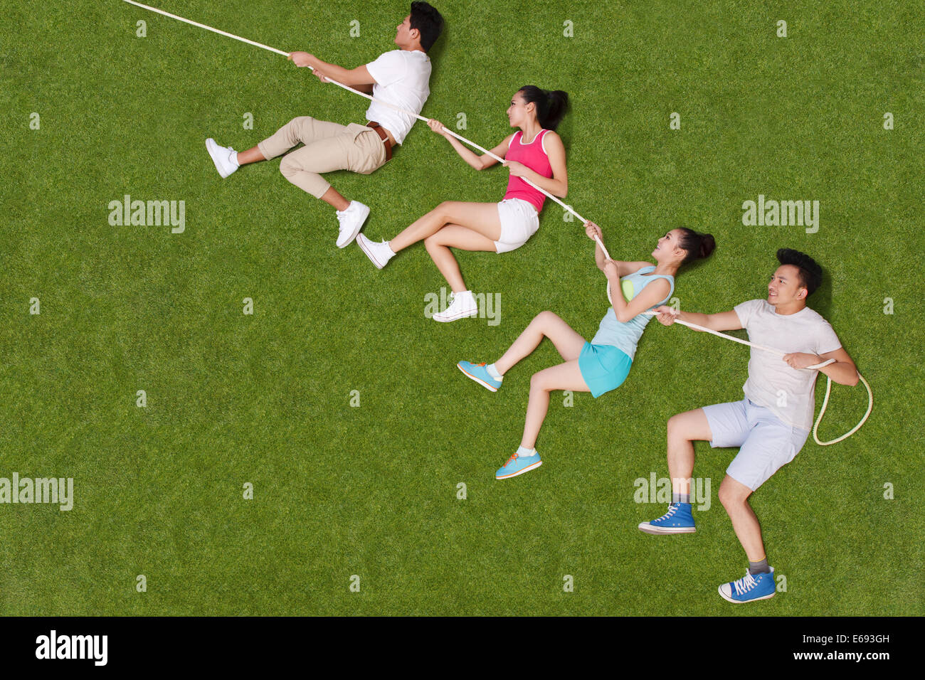 young people pulling a long rope Stock Photo - Alamy