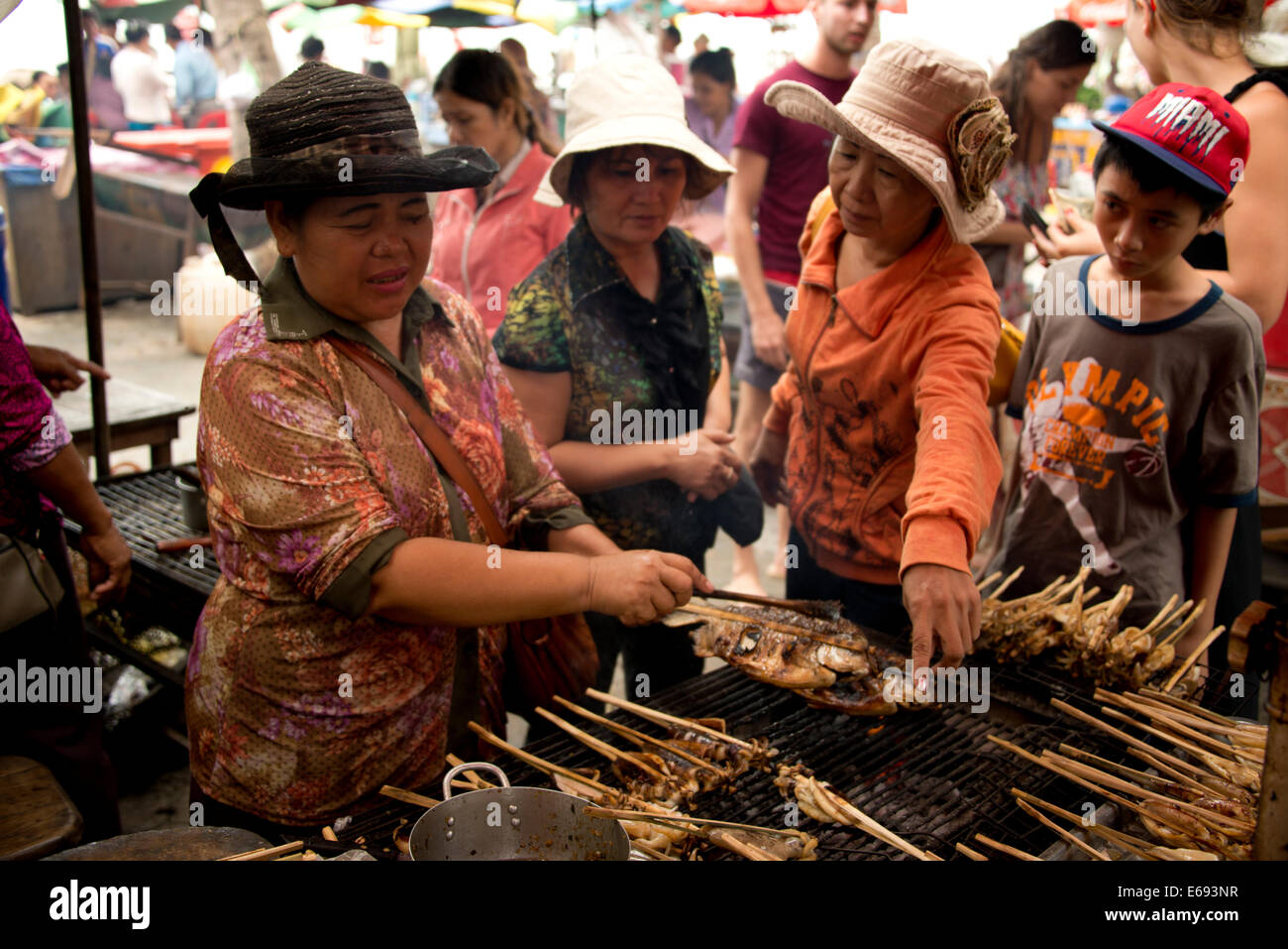 Woman cooking fish at market, Cambodia Stock Photo - Alamy