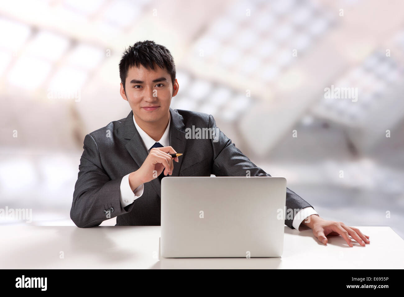 Young businessman using laptop Stock Photo - Alamy