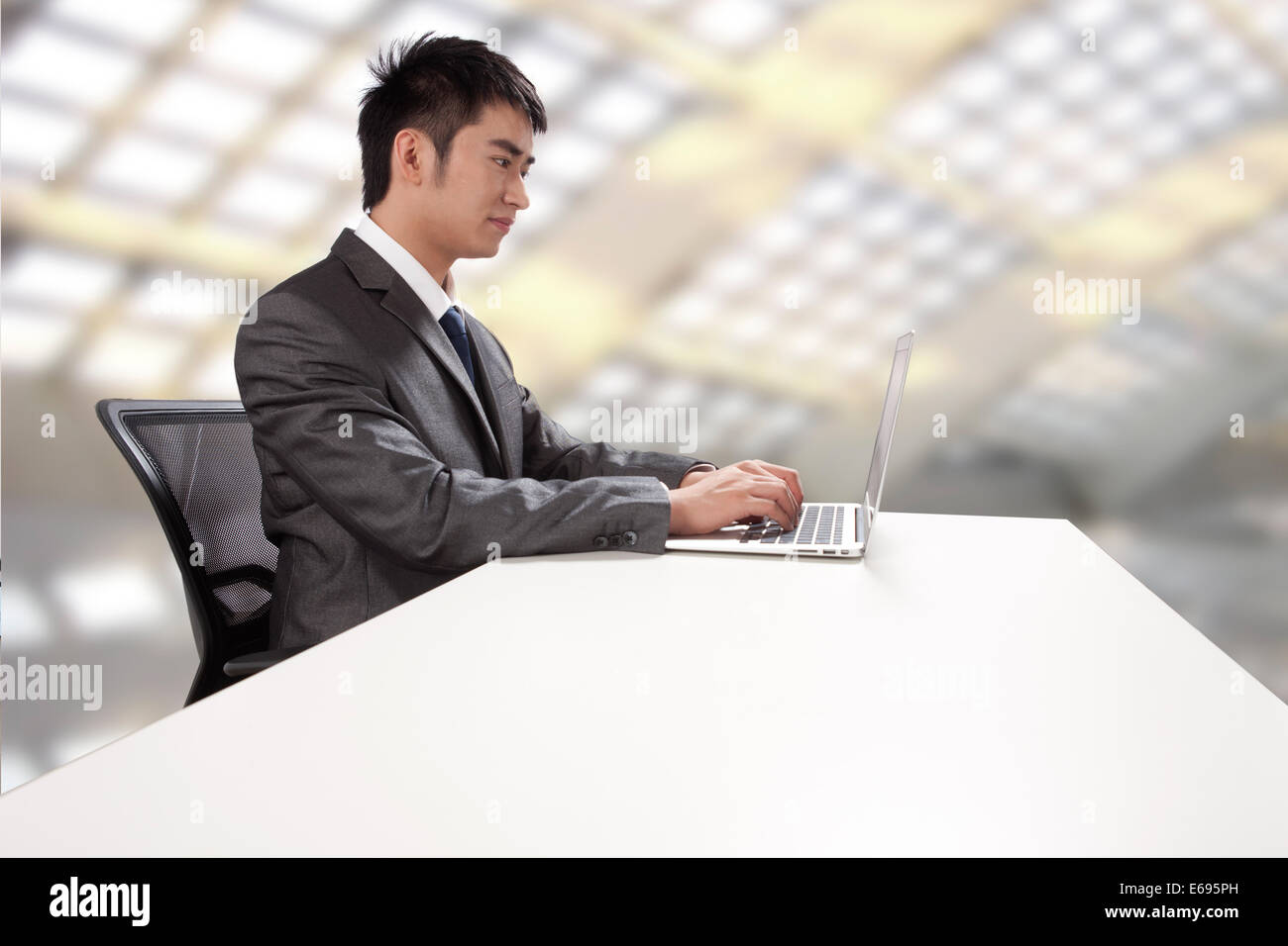 Young businessman using laptop Stock Photo - Alamy