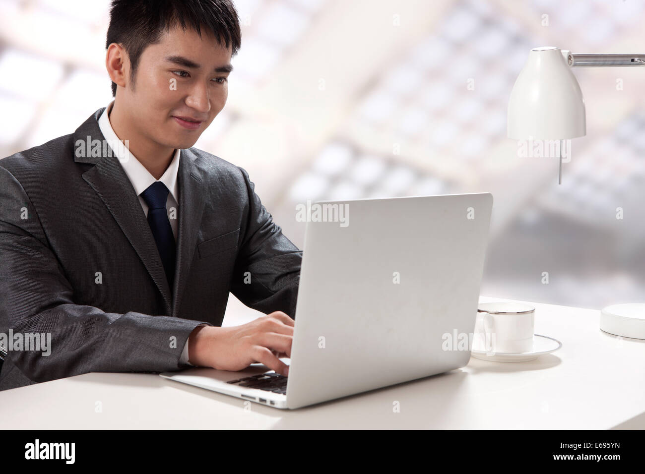 Young businessman using laptop Stock Photo - Alamy
