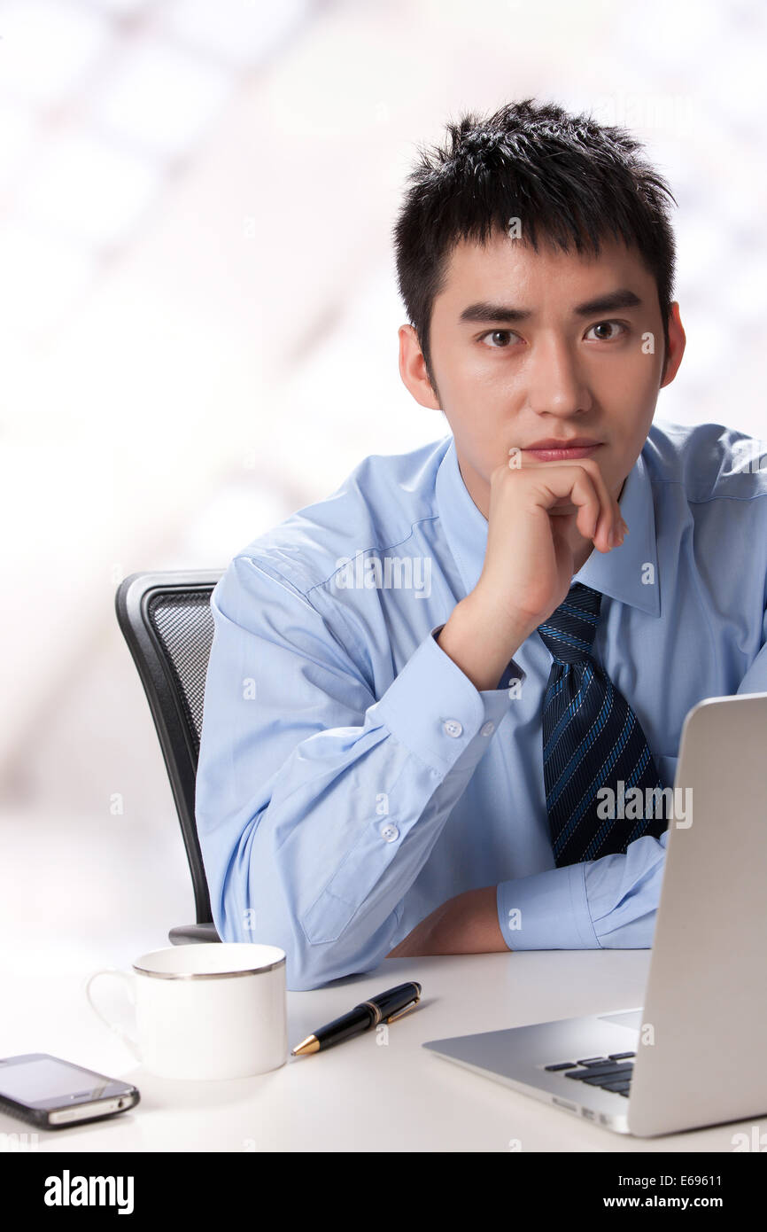Young businessman using laptop Stock Photo - Alamy