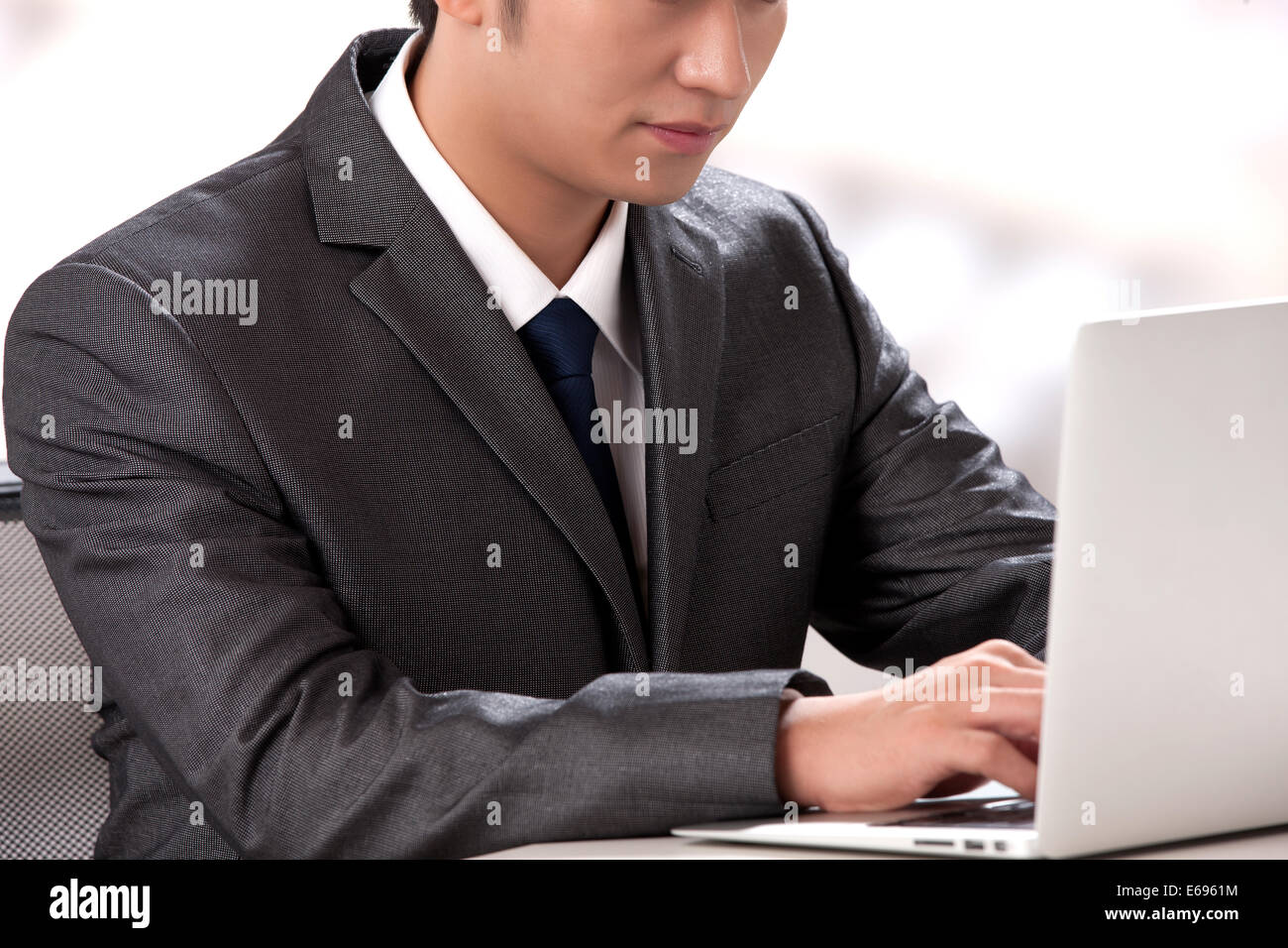 Young businessman using laptop Stock Photo - Alamy