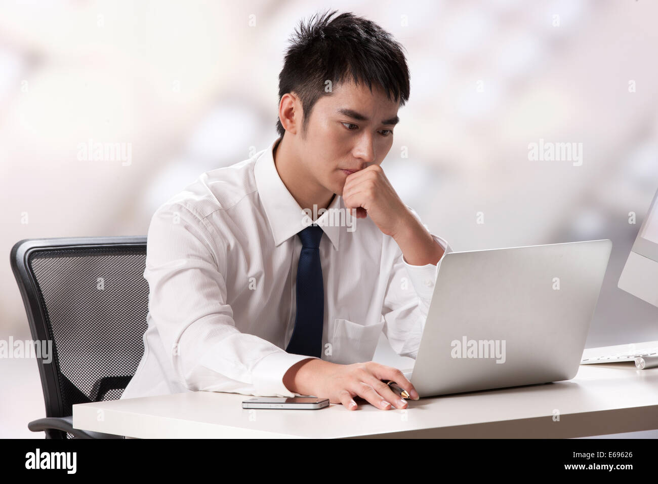 Young businessman using laptop Stock Photo - Alamy