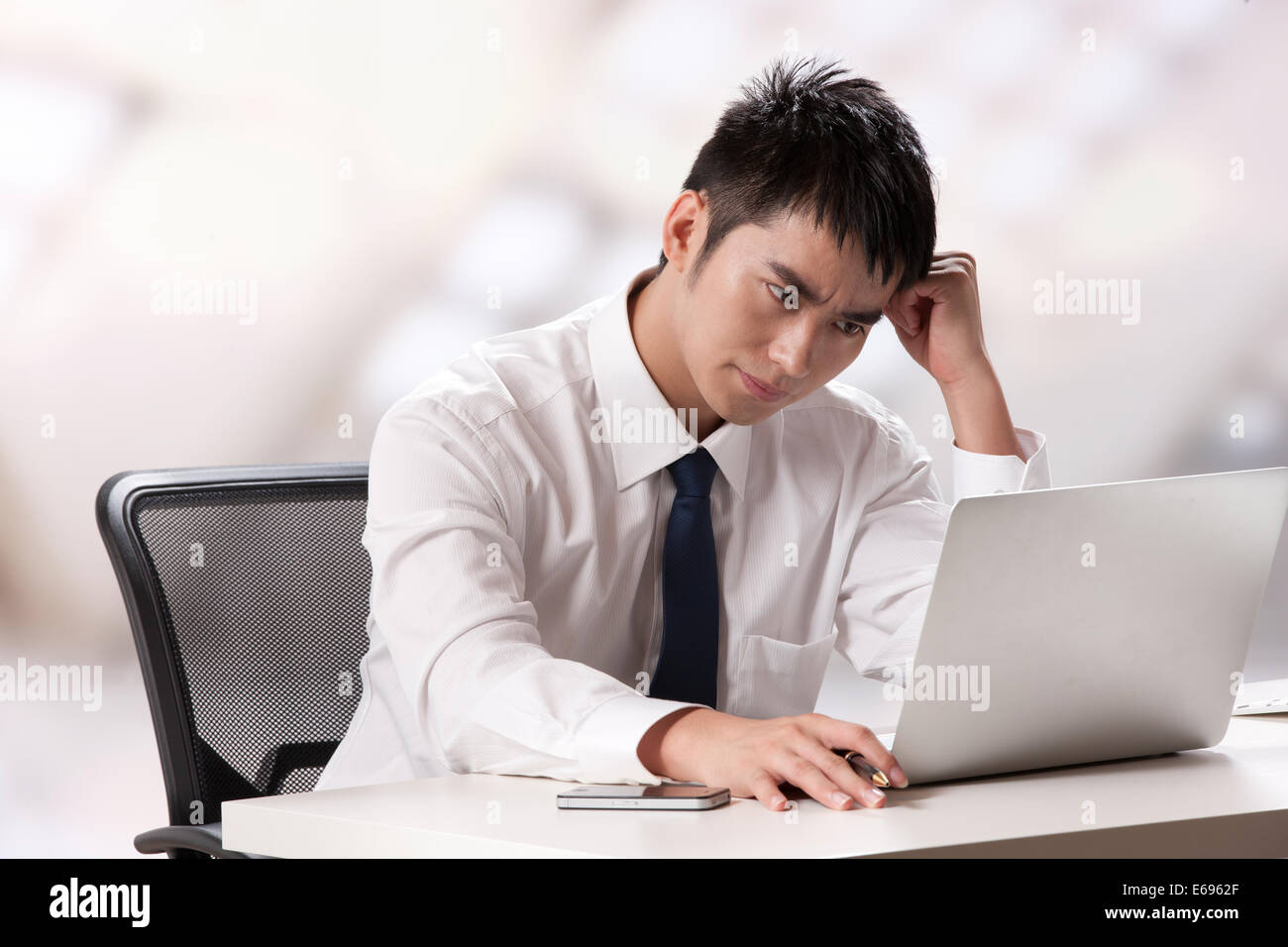 Young businessman using laptop Stock Photo - Alamy