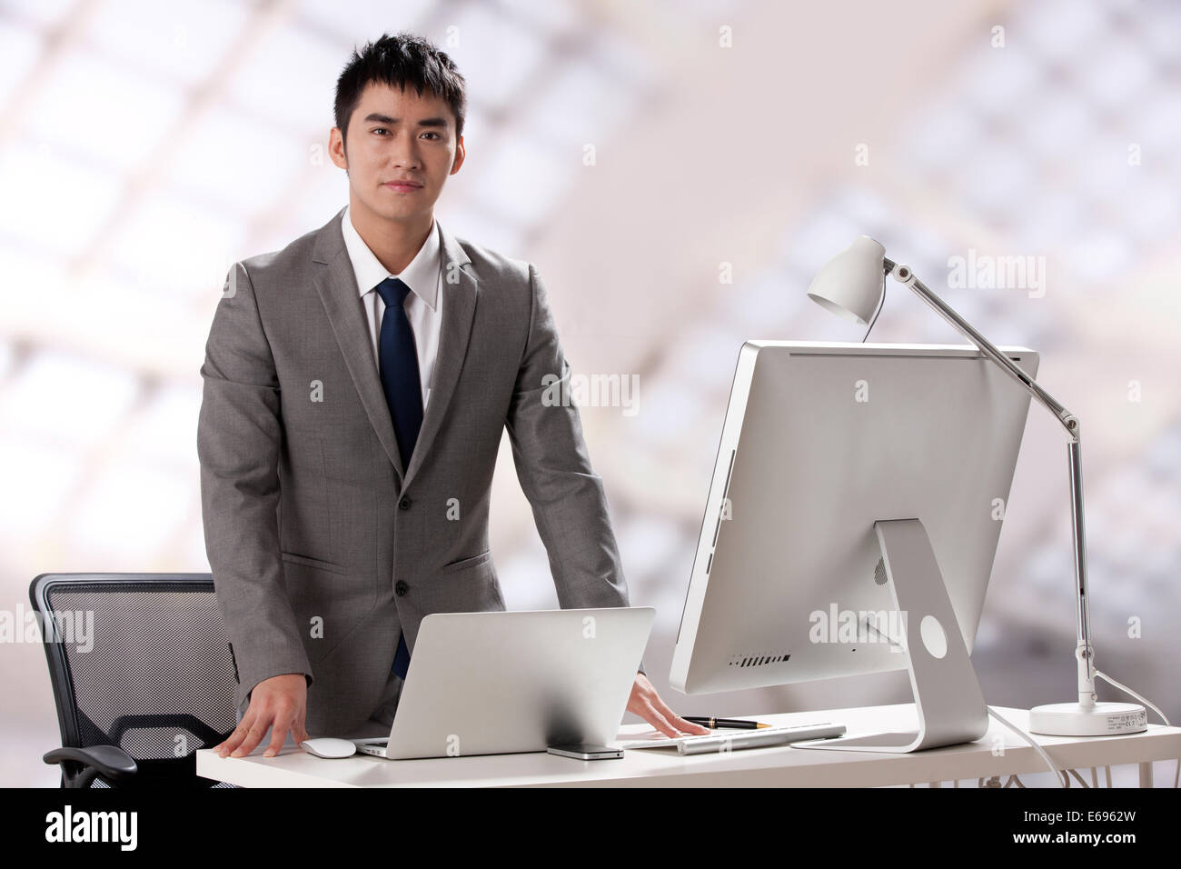 Young businessman using laptop Stock Photo - Alamy