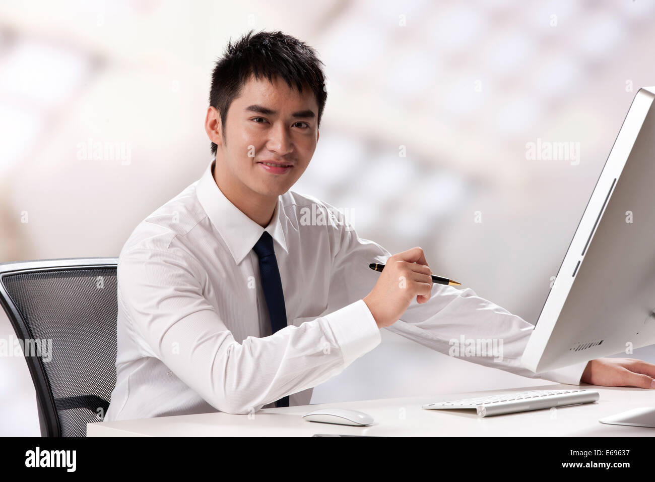 Young businessman using laptop Stock Photo - Alamy