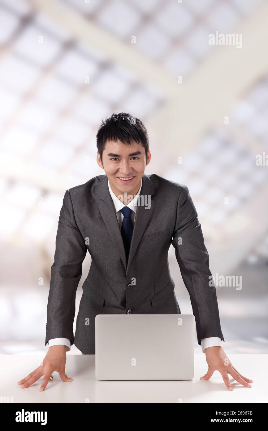 Young businessman using laptop Stock Photo - Alamy