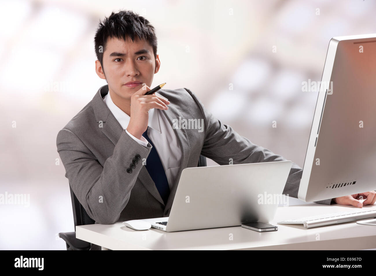 Young businessman using laptop Stock Photo - Alamy