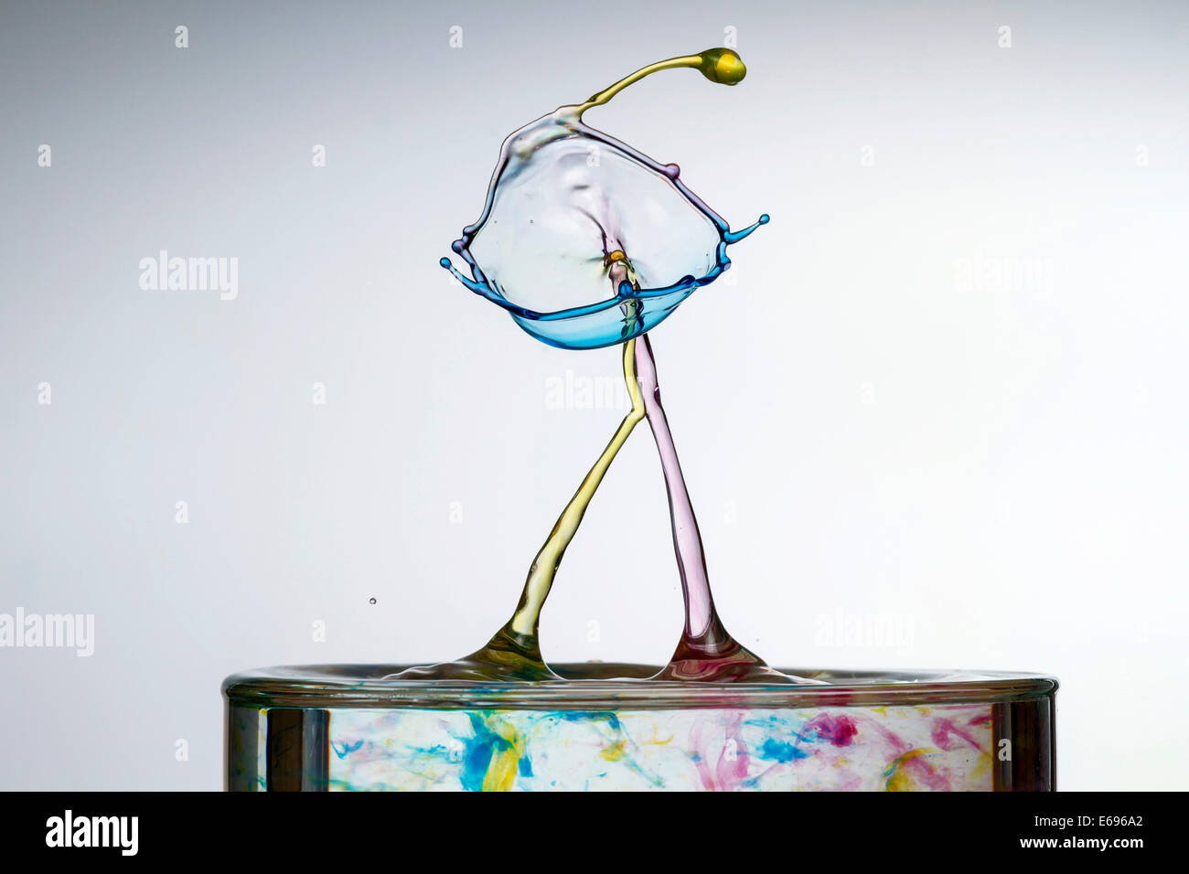 Three different coloured drops colliding Stock Photo - Alamy