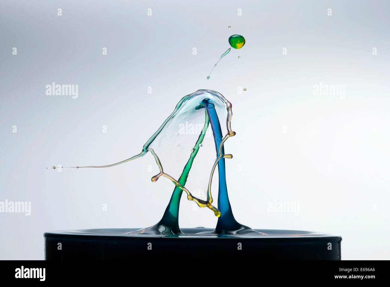 Three different coloured drops colliding Stock Photo - Alamy