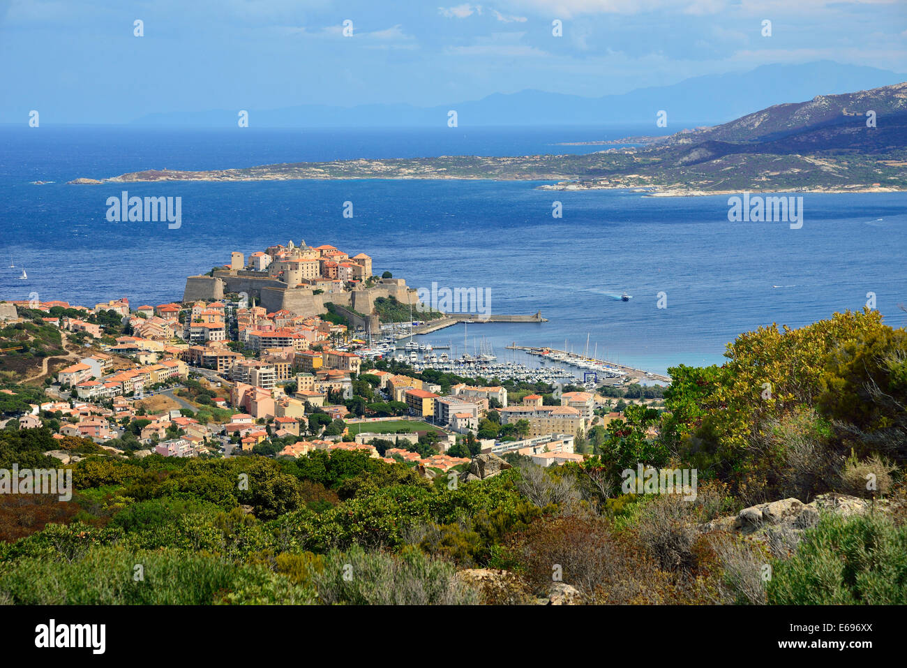 View of the town with the harbor and the citadel, Calvi, Corsica ...