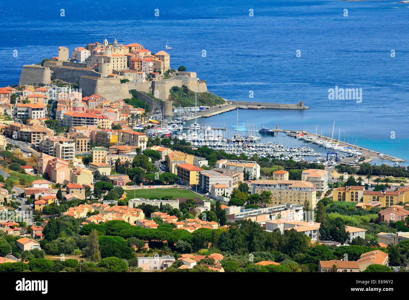 View of the town with the harbor and the citadel, Calvi, Corsica ...