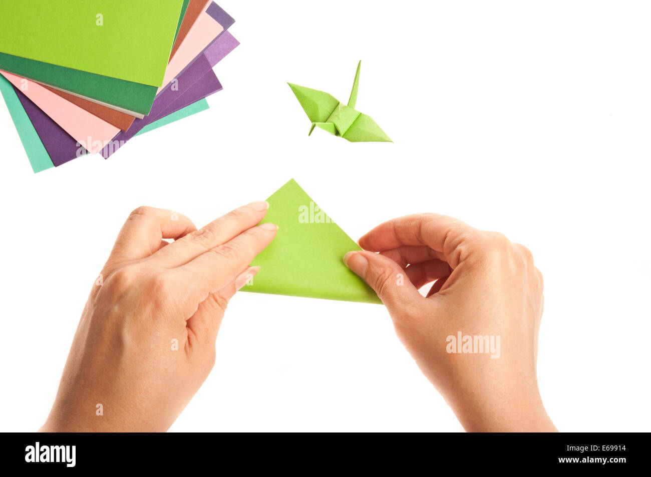 hands folding an origami bird Stock Photo - Alamy