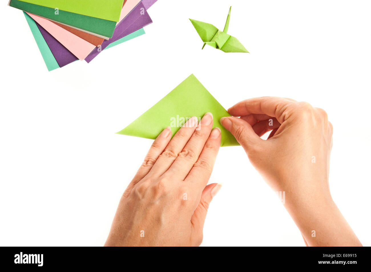 hands folding an origami bird Stock Photo - Alamy