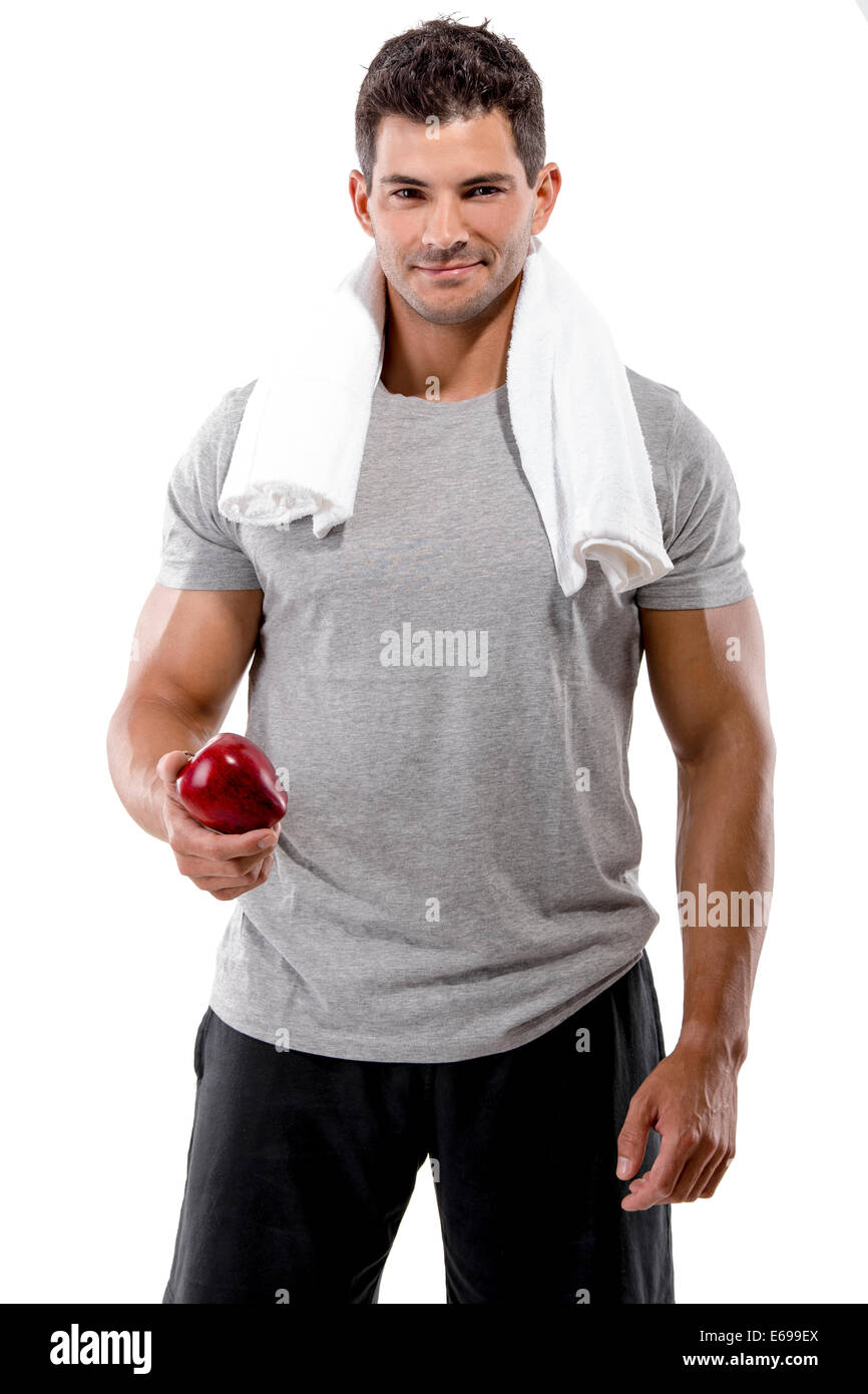 Portrait of a athletic man holding a apple, isolated over a white ...