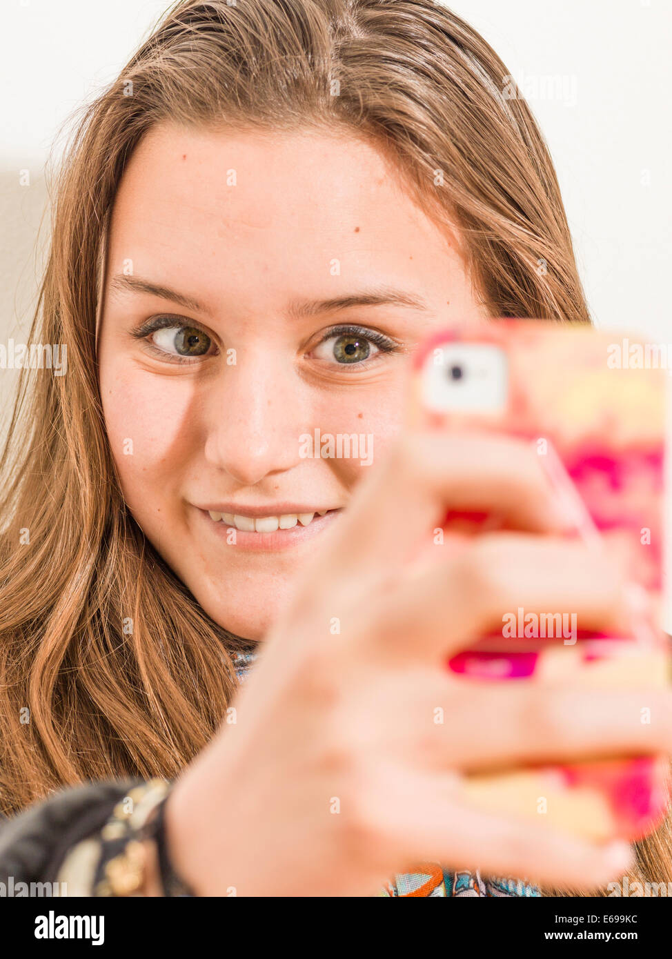 Caucasian teenage girl taking picture with cell phone Stock Photo - Alamy