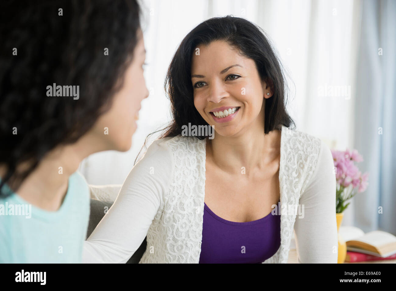 Mother and daughter talking in living room Stock Photo - Alamy