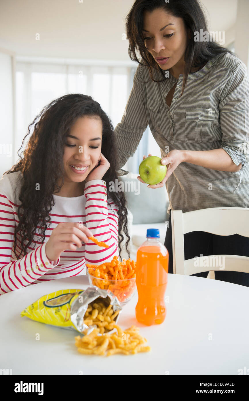 Mother offering daughter healthy snack Stock Photo - Alamy