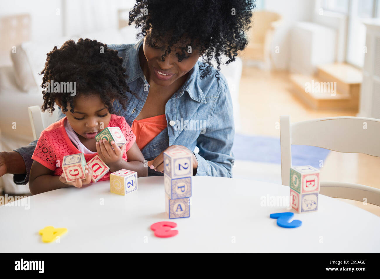Mother and daughter playing with wooden blocks Stock Photo - Alamy