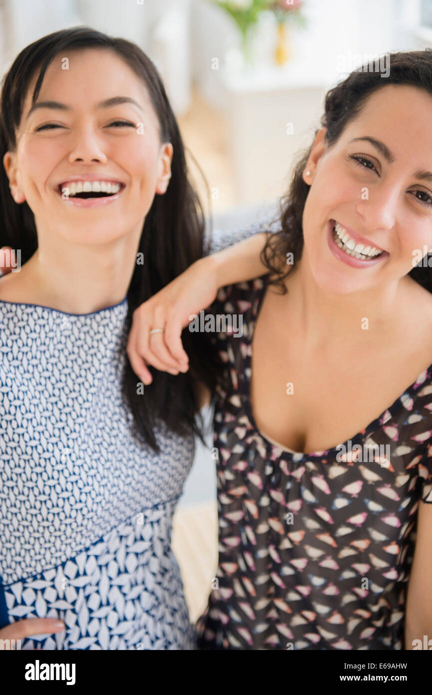 Smiling women standing together Stock Photo - Alamy