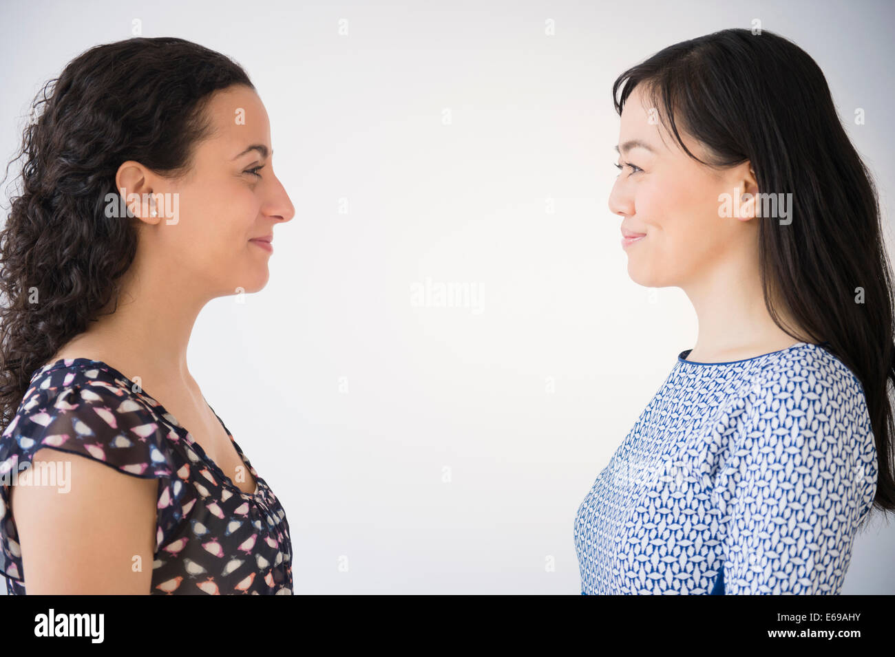 Women smiling at each other Stock Photo - Alamy
