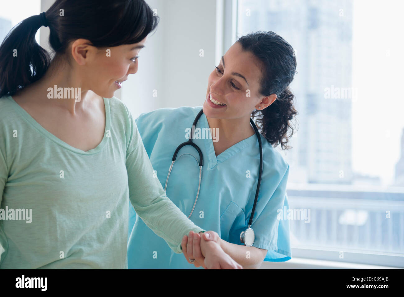 Nurse helping patient in hospital Stock Photo - Alamy