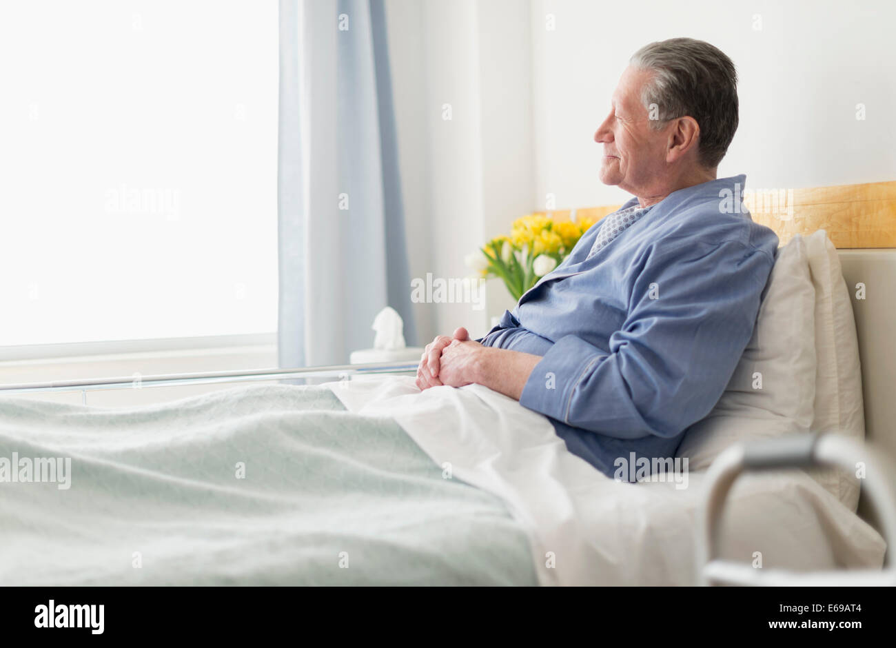 Senior Caucasian man sitting in hospital bed Stock Photo - Alamy