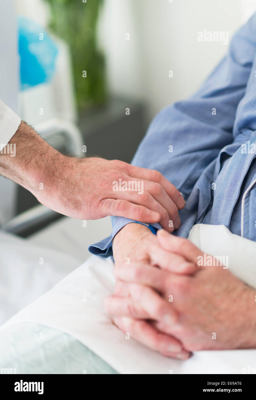 Caucasian doctor reassuring patient in hospital Stock Photo - Alamy