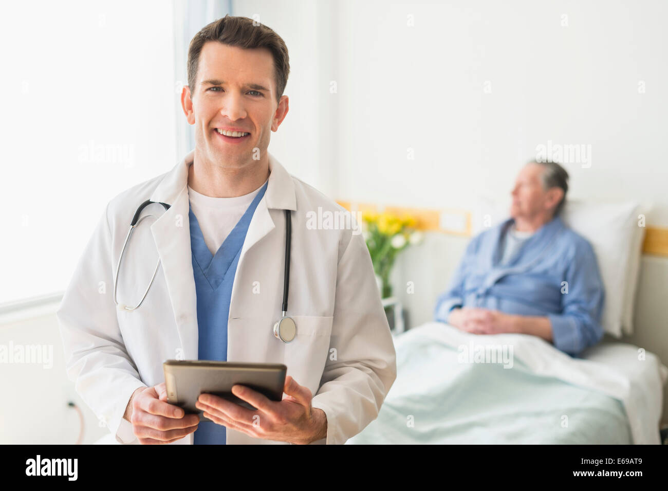 Caucasian doctor using digital tablet in hospital Stock Photo - Alamy