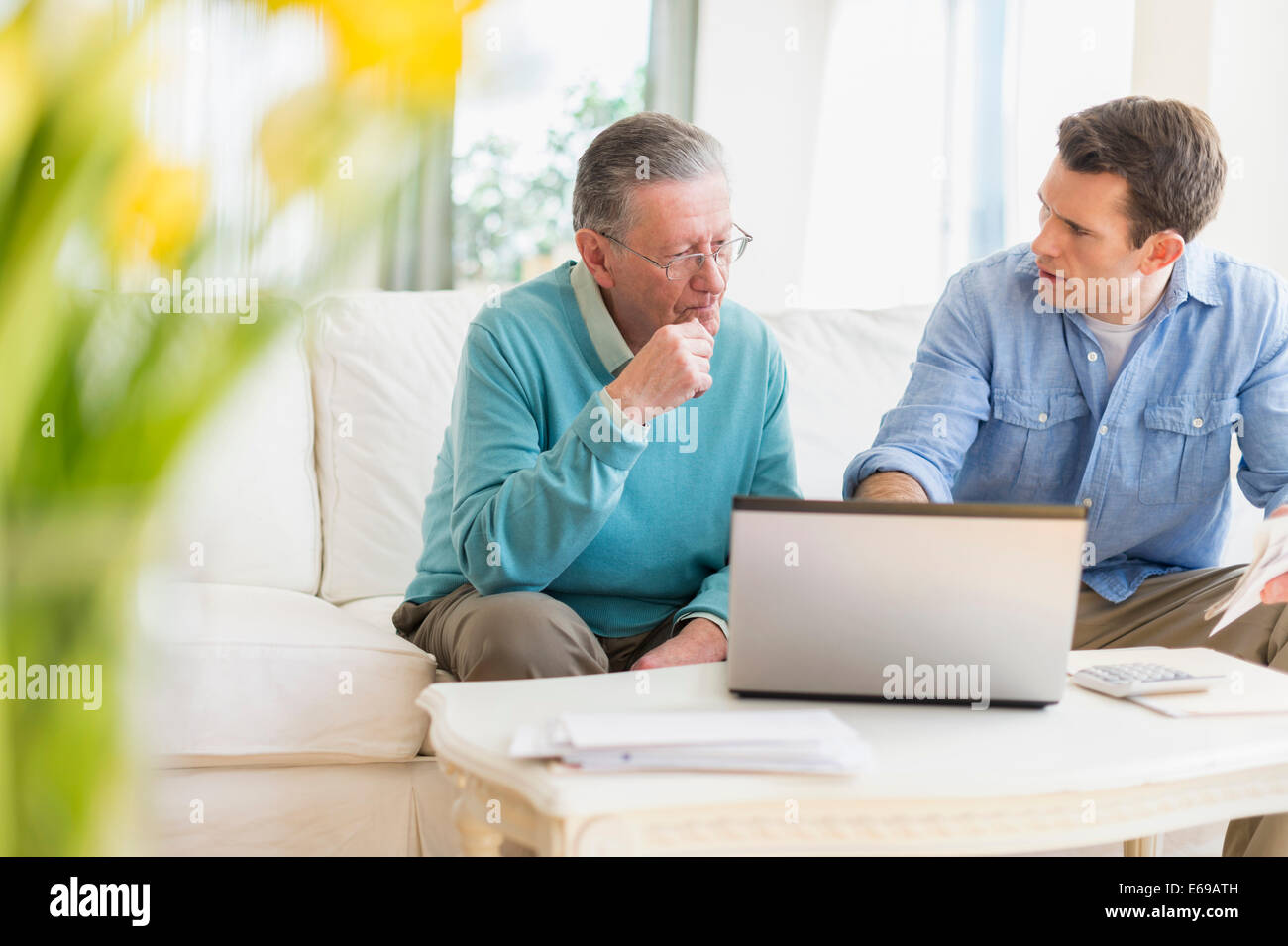 Caucasian man helping father use computer Stock Photo - Alamy