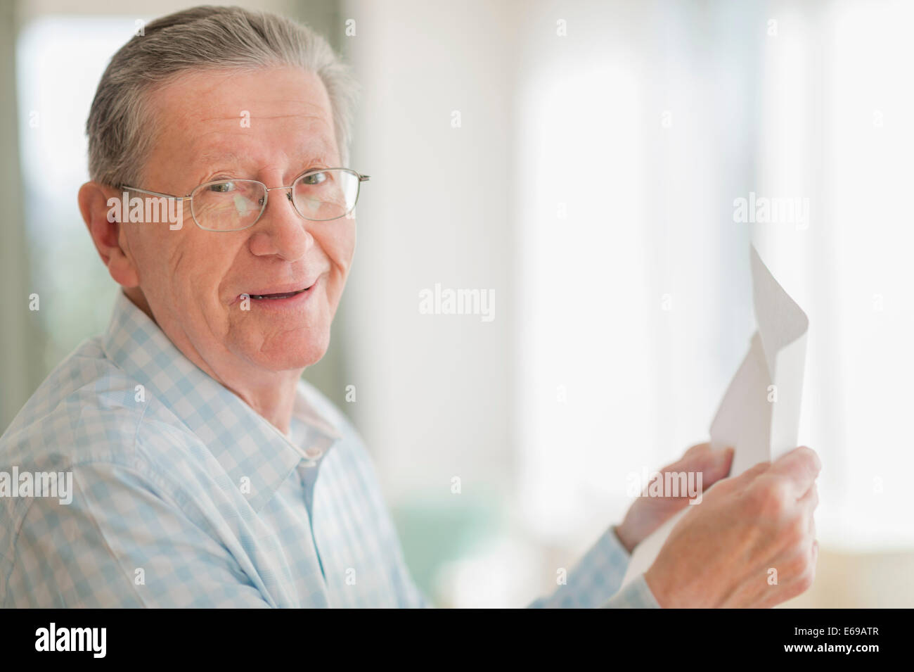 Senior Caucasian man reading letter Stock Photo - Alamy