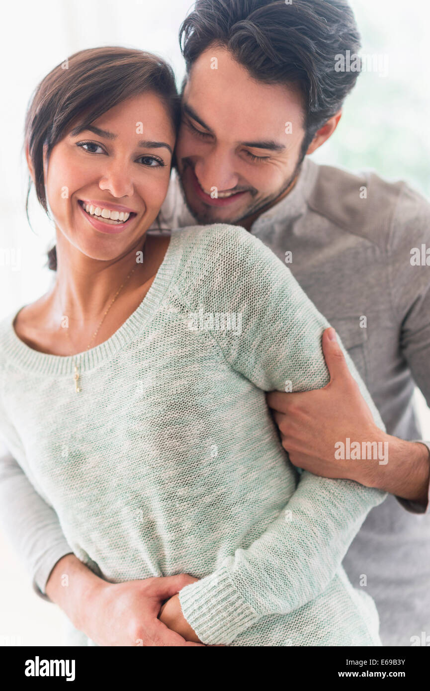 Couple hugging indoors Stock Photo - Alamy