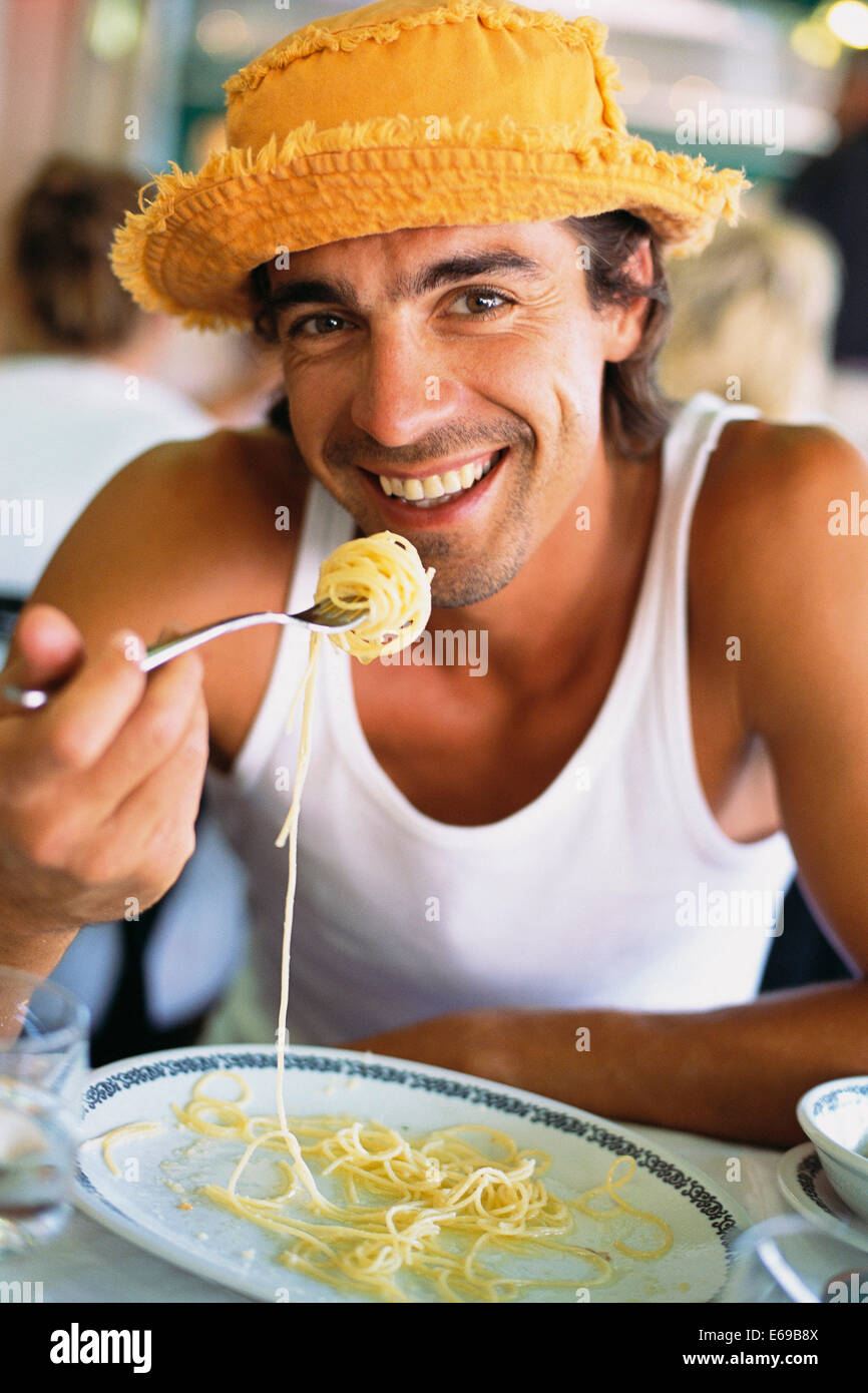 Man eating pasta at sidewalk cafe Stock Photo - Alamy