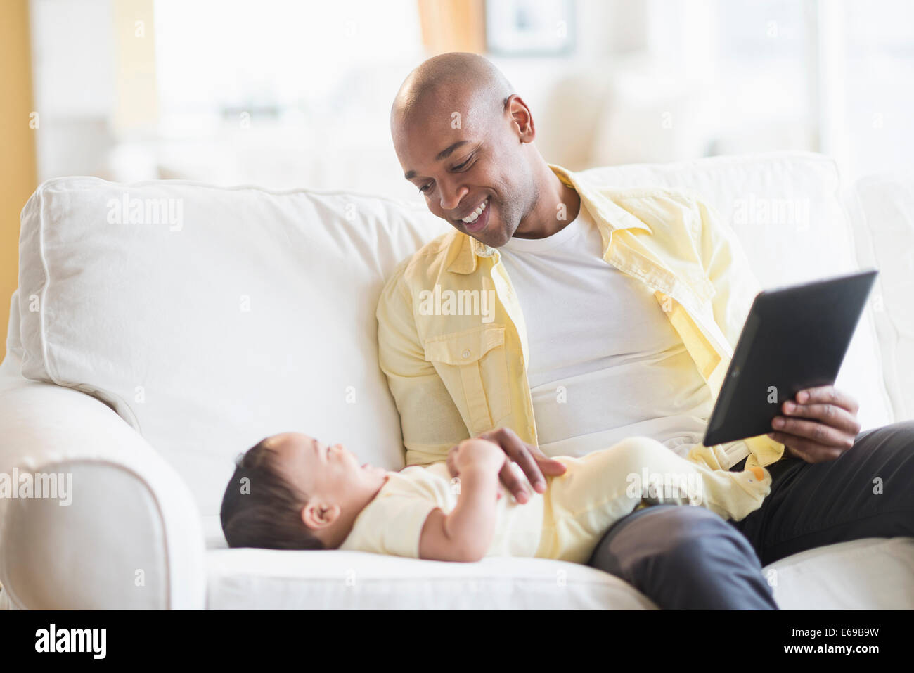 Smiling father playing with baby Stock Photo - Alamy