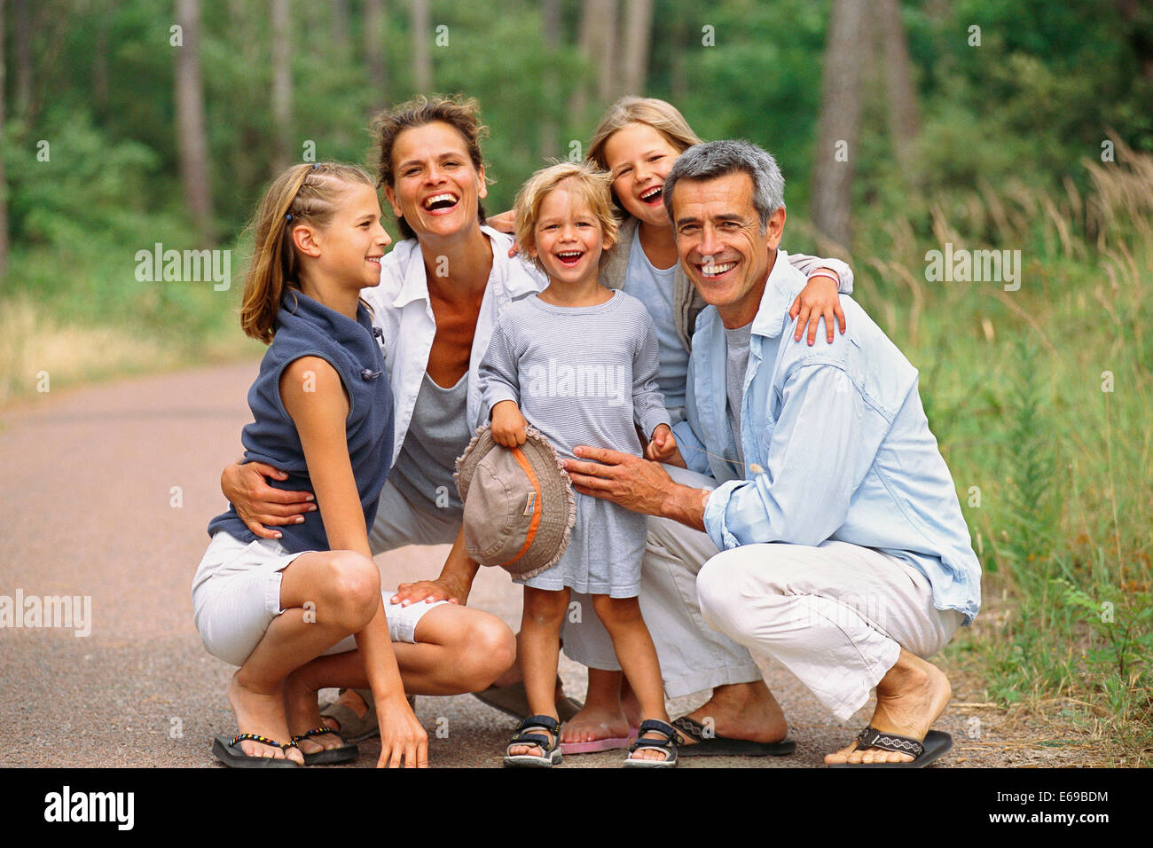 Caucasian family smiling in park Stock Photo - Alamy