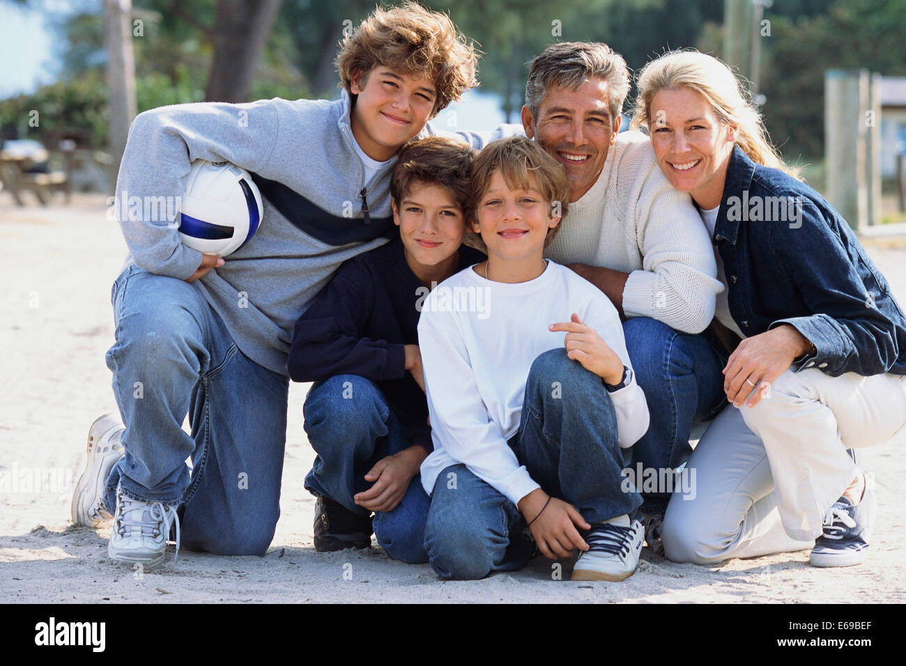 Family smiling together in park Stock Photo - Alamy