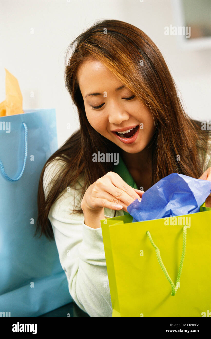 Woman opening presents Stock Photo - Alamy